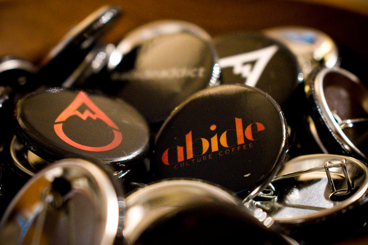 Abide Culture Logo Button in Orange | Abide Culture Coffee Roasters